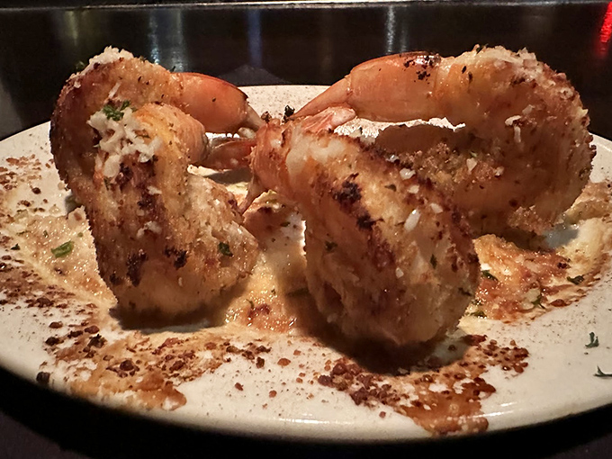 Baked shrimp that look like they've been working out – massive, succulent, and dressed to impress with a dusting of herbs.