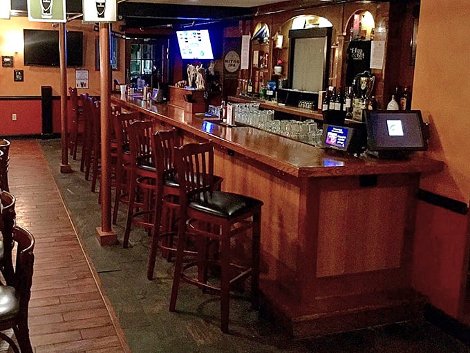 The bar stretches invitingly, promising perfectly poured pints of Guinness and whiskey wisdom from bartenders who know their Irish spirits.