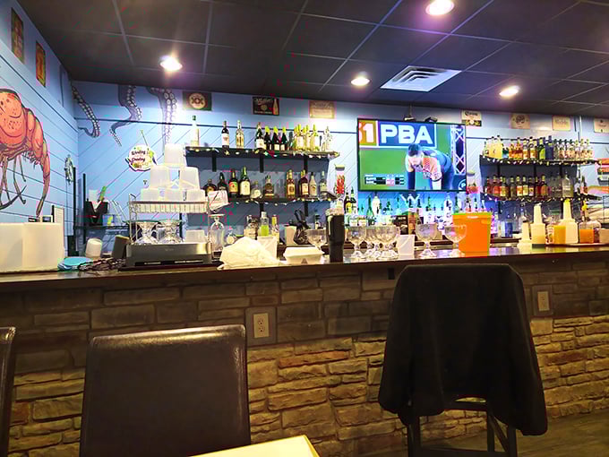 The bar area showcases an impressive lineup of liquid courage. Perfect for those about to battle a mountain of crab legs.