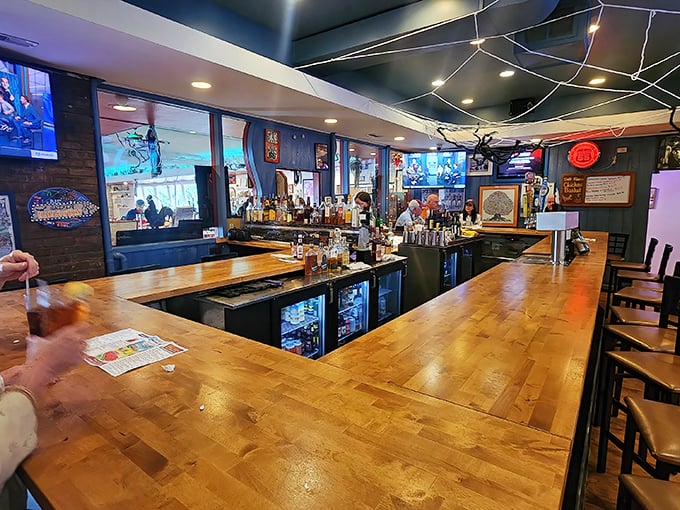 The bar area – where cocktails meet comfort in a wood-paneled sanctuary of hospitality and good cheer.