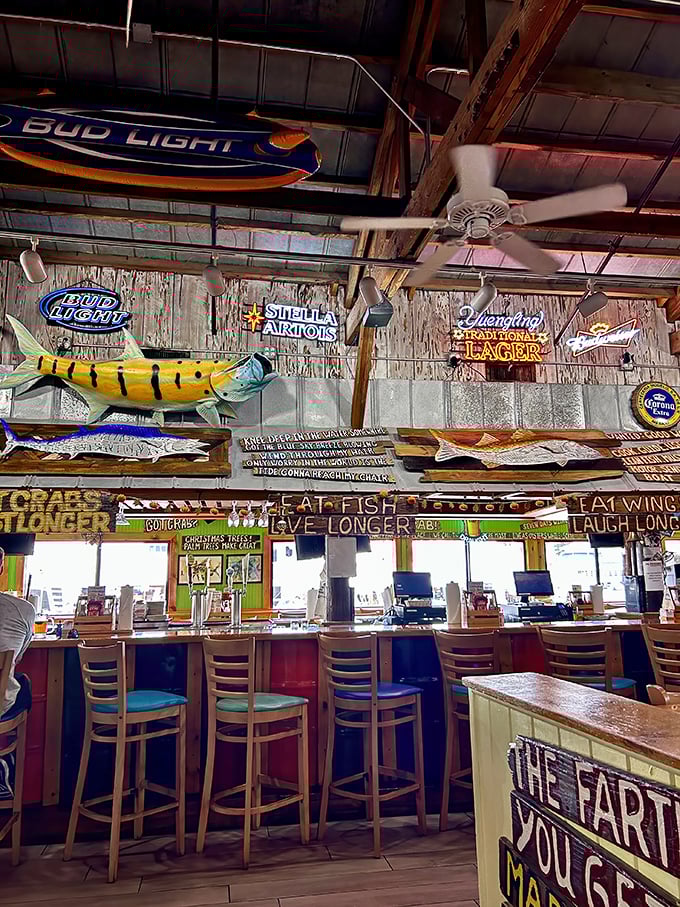 Where beer signs and fishing trophies hang like maritime medals of honor. The sign says it all—eat fish, live longer, laugh louder.