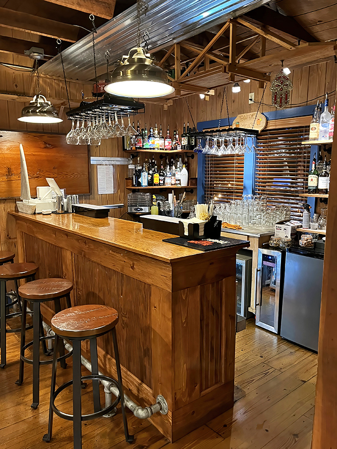 The bar area—where seafood stories get better with each round. Those hanging glasses are just waiting for their moment.