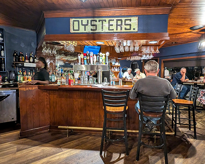 The "OYSTERS" sign above the bar isn't just decoration—it's a promise. This is a place that takes its Chesapeake Bay bounty seriously.
