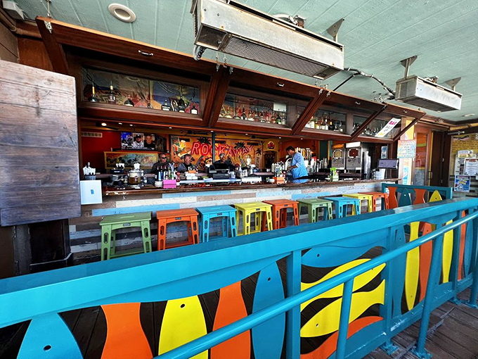 The rainbow of bar stools looks like a box of crayons melted in the Florida sun—in the best possible way.