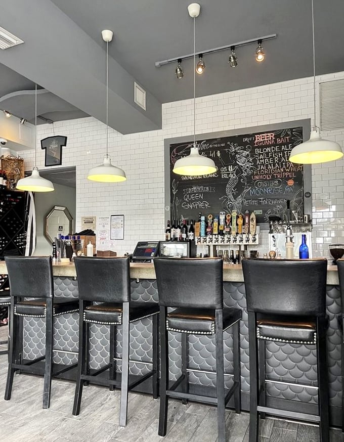 The bar where seafood dreams begin. Mermaid-scale detailing and subway tiles create the perfect backdrop for maritime cocktail adventures.