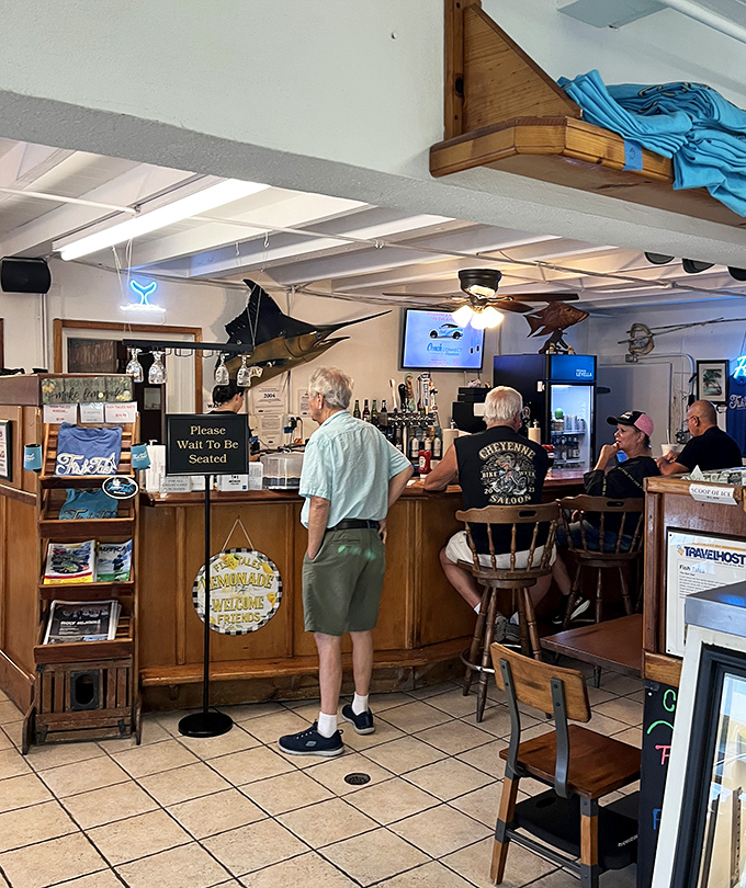 The bar area—where fishing tales grow taller and seafood tastes fresher with each passing hour.