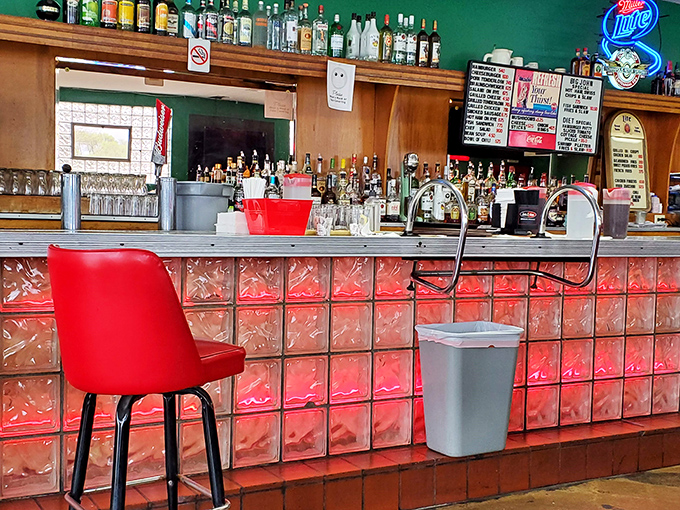 The bar area sports the kind of authentic vintage charm that hipster establishments spend thousands trying to replicate. Those red-tiled accents have witnessed decades of stories.