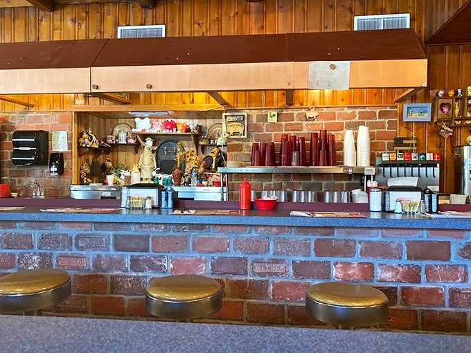 The counter where breakfast dreams come true, complete with brick facade and stools that have supported generations of hungry patrons.