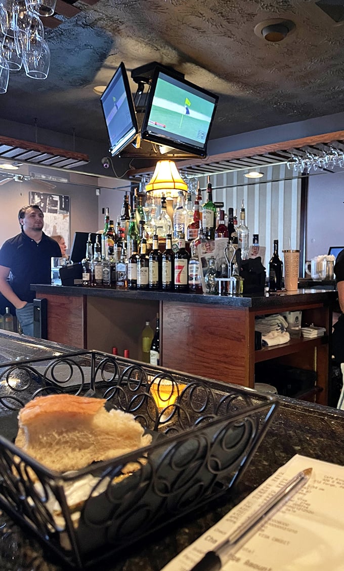The bar's impressive bottle display isn't just inventory—it's a promise of possibilities, from classic cocktails to creative concoctions.