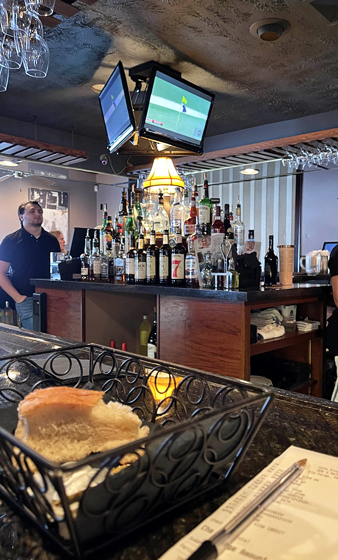 The bar's impressive bottle display isn't just inventory—it's a promise of possibilities, from classic cocktails to creative concoctions.