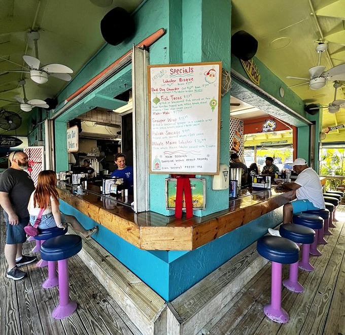 Pull up a colorful stool to this corner bar where specials are scrawled with care and regulars exchange fishing tales between bites.