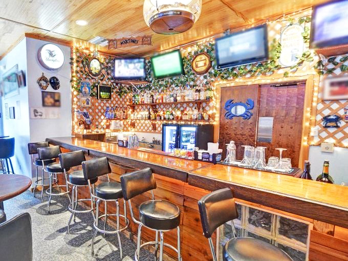 The bar area combines rustic wood with nautical touches—where cold drinks and warm conversation create the perfect Florida evening.