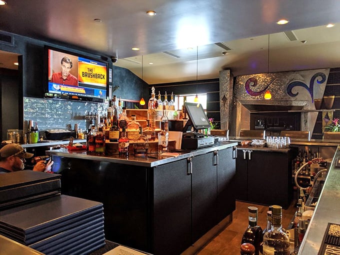 The bar: where spirits meet spirited conversation. That mosaic fireplace isn't just for show—it's warming souls and inspiring second rounds since day one.