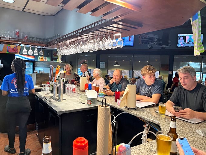 The bar: where solo diners become regulars and bartenders double as therapists. Those hanging glasses await their moment.