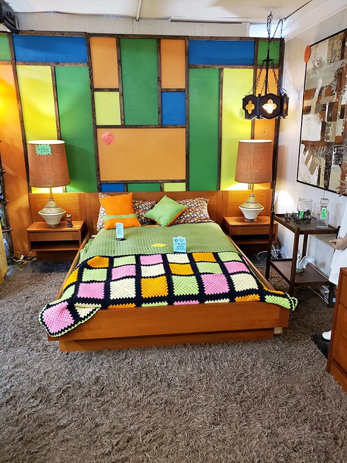 A bedroom display that's pure retro joy with stained glass headboard and matching nightstands. The 1970s called—they're jealous you found this first!
