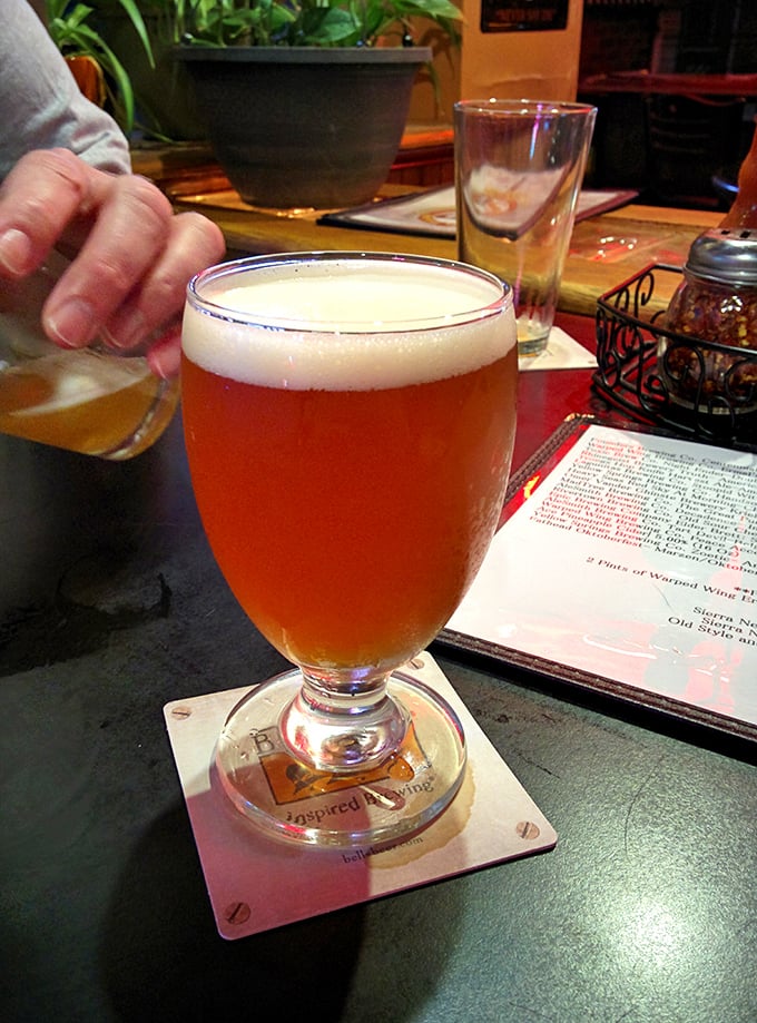 Amber beer catches the light like liquid sunshine in a glass. The perfect companion for pizza adventures and conversation that flows as smoothly as the brew.