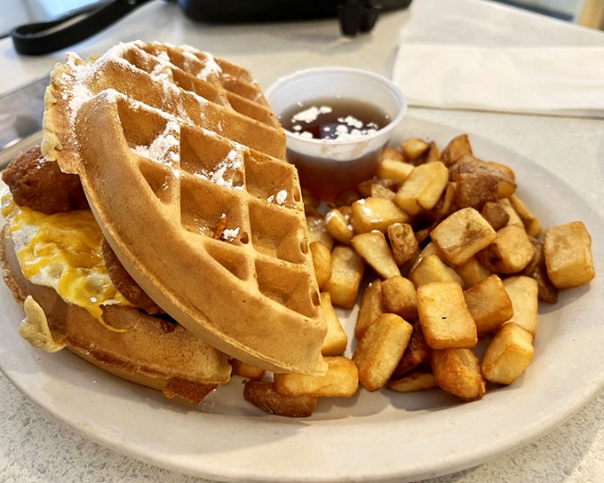The Belgian Bird Sandwich defies gravity and good sense – a waffle embracing chicken with the enthusiasm of a long-lost relative. 