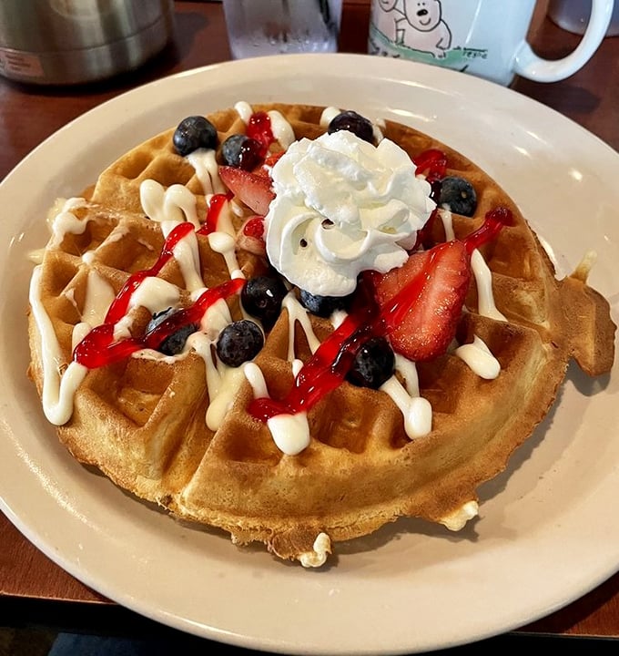 This Belgian waffle, crowned with berries and cream, isn't just breakfast—it's an event. The kind worth planning your weekend around.