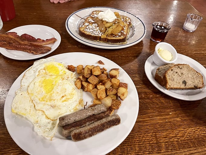 The breakfast trinity: perfectly fried eggs, golden home fries, and sausage links – a plate that says "good morning" in the most delicious language.