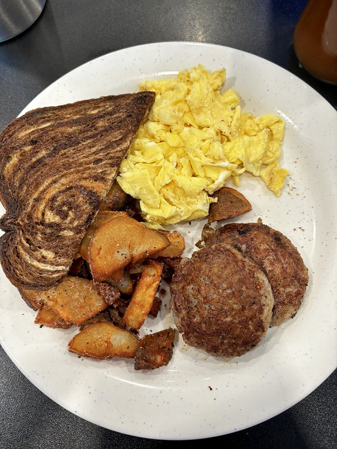 Breakfast democracy in action—eggs, meat, potatoes, and toast, all getting equal time on the plate and in your heart.