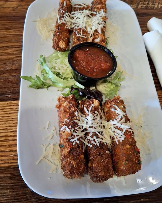 These aren't your average mozzarella sticks—they're golden-brown, cheese-filled torpedoes of happiness, dusted with parmesan and served with marinara for dipping.