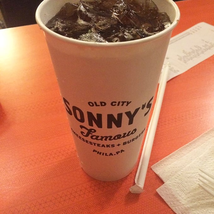 That iconic Sonny's cup filled with dark, bubbly refreshment – the perfect liquid companion to cut through all that cheesy goodness.