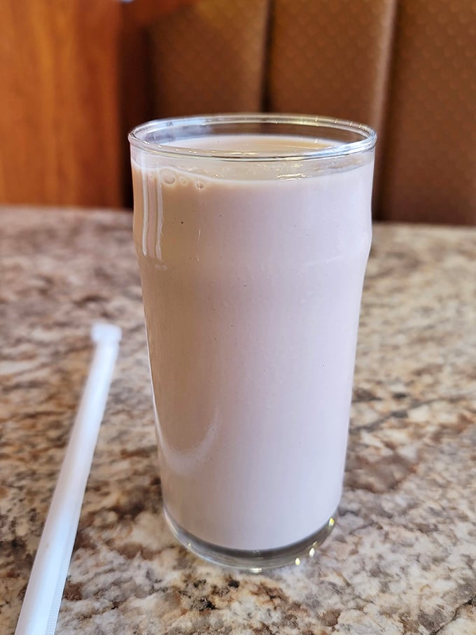 A milkshake so thick it's practically standing at attention – the straw is more aspirational than functional at this point.