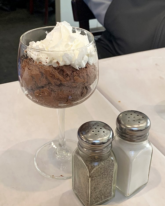 Chocolate mousse that defies gravity with its lightness. The whipped cream hat is just showing off.