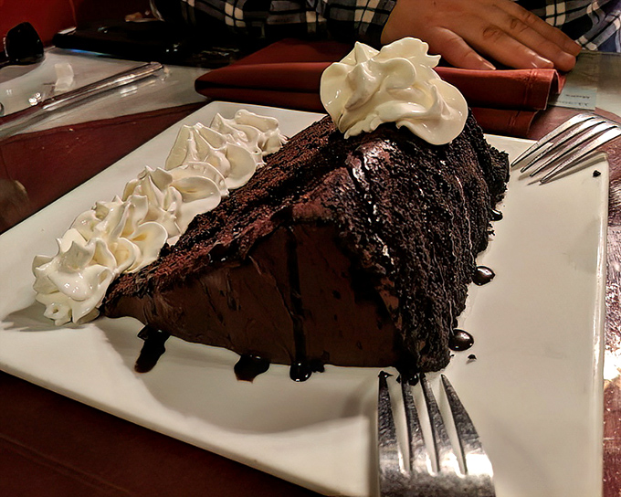 This chocolate cake isn't playing around—it's serious about its mission to deliver maximum chocolate impact. The whipped cream isn't a garnish—it's a necessary cooling agent.