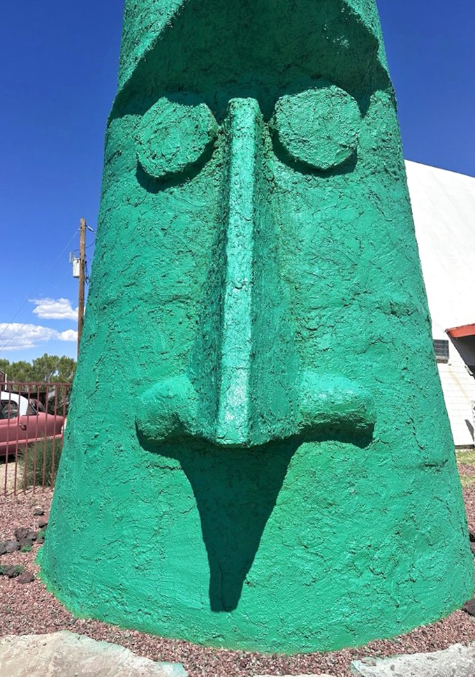 Up close, the textured surface reveals the craftsmanship behind this concrete curiosity—each imperfection adding character to its stoic face.