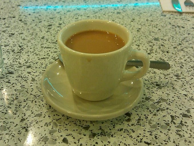 Coffee served in a classic diner mug—the kind that feels like it's been warming hands and hearts since the Eisenhower administration.