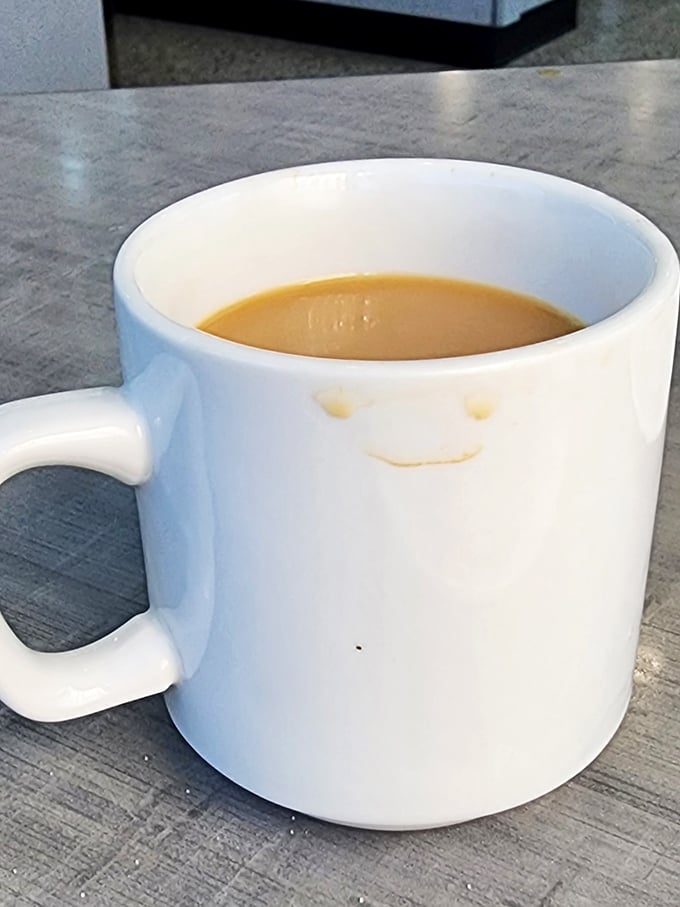 The coffee mug that smiles back at you – a caffeinated friend ready to help you tackle the extensive menu choices ahead.