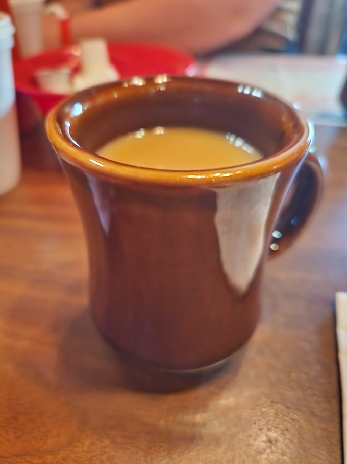Coffee served in a sturdy brown mug that feels like it's been in your hand a thousand times before—familiar, comforting, and ready for refills.