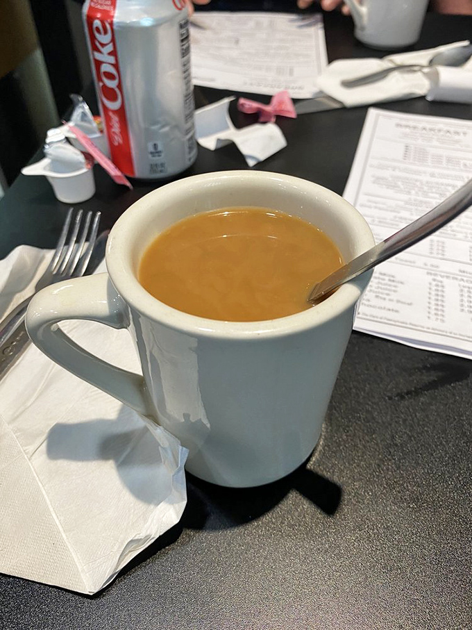 That perfect diner coffee moment—slightly worn menu in the background, creamy brew in the foreground, and endless possibilities in between.