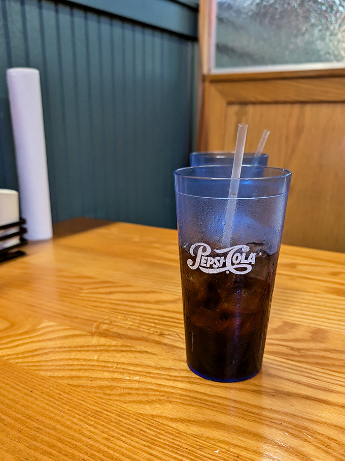 That blue Pepsi glass isn't just holding soda—it's preserving a tradition of proper Southern sweet tea service that pairs perfectly with smoky meats.