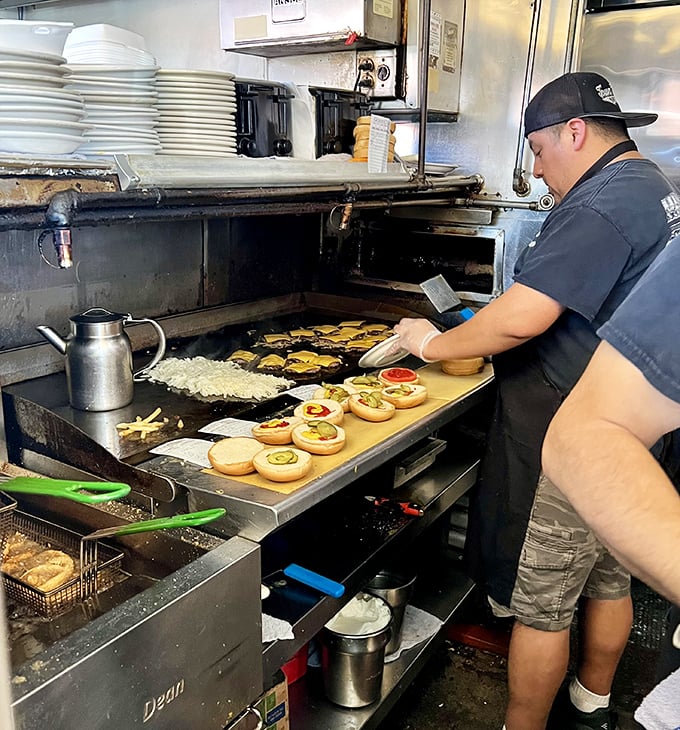 The flat-top grill—where burger magic happens in plain sight, no smoke and mirrors, just decades of seasoned steel and know-how.