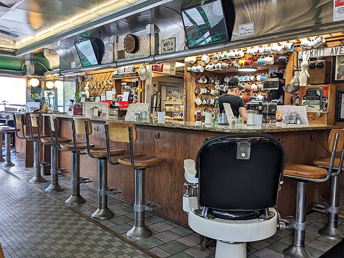 The counter—where solo diners find community, coffee cups never reach empty, and the mug collection tells stories of diners past.