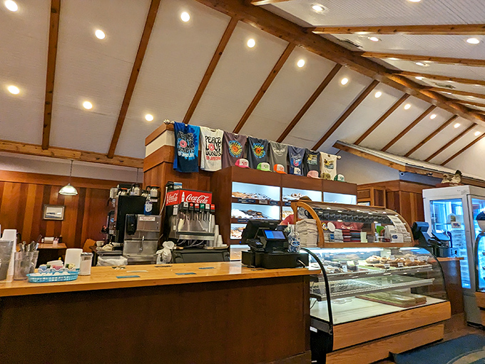 Behind this counter, breakfast magic happens daily. The donut display case is where willpower goes to die.