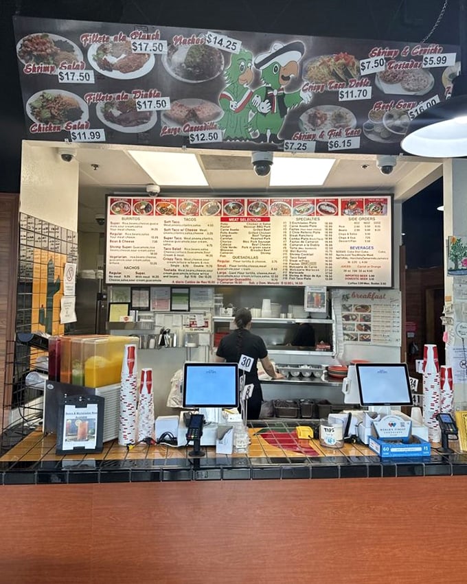 Where the magic happens—the ordering counter stands ready with its colorful menu board and cartoon mascots promising delicious possibilities just minutes away.