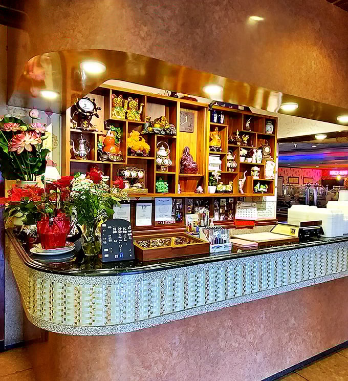 The ornate host station welcomes guests with Eastern flair, shelves of decorative treasures setting the tone for your culinary journey.
