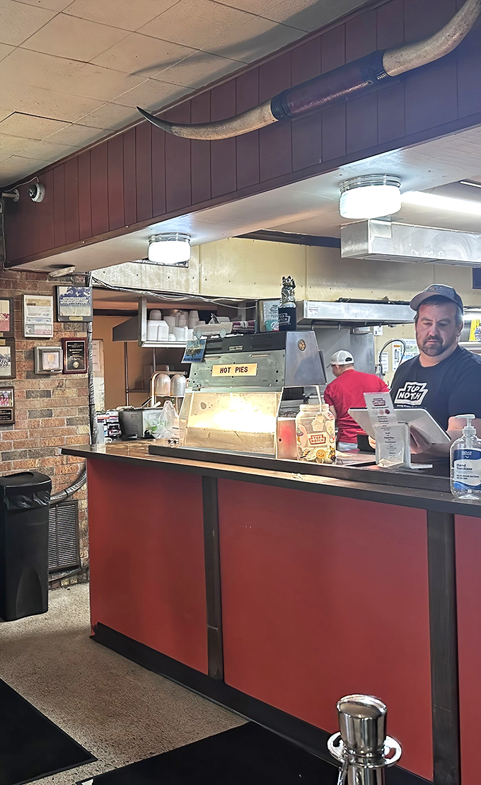 Behind this counter, culinary magic happens without fanfare or fuss—just decades of know-how and the sizzle of a well-seasoned grill.