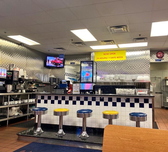 The counter seats—front row tickets to the greatest show on earth: short-order cooks performing culinary choreography with practiced precision.