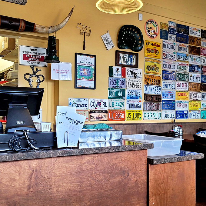The counter area showcases an impressive collection of license plates—a road trip across America without leaving your breakfast stool.