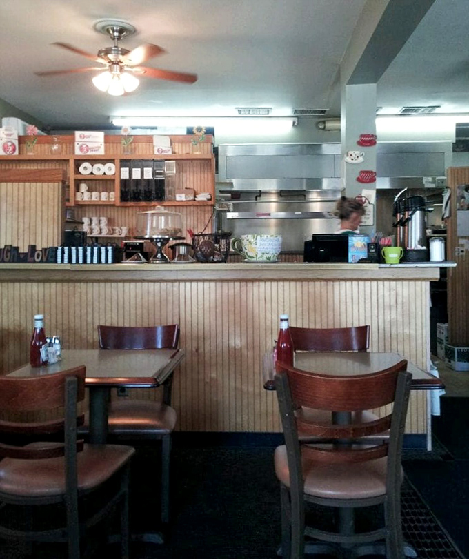 The beating heart of any great diner—a counter where coffee flows freely and the kitchen symphony plays out behind wooden wainscoting.