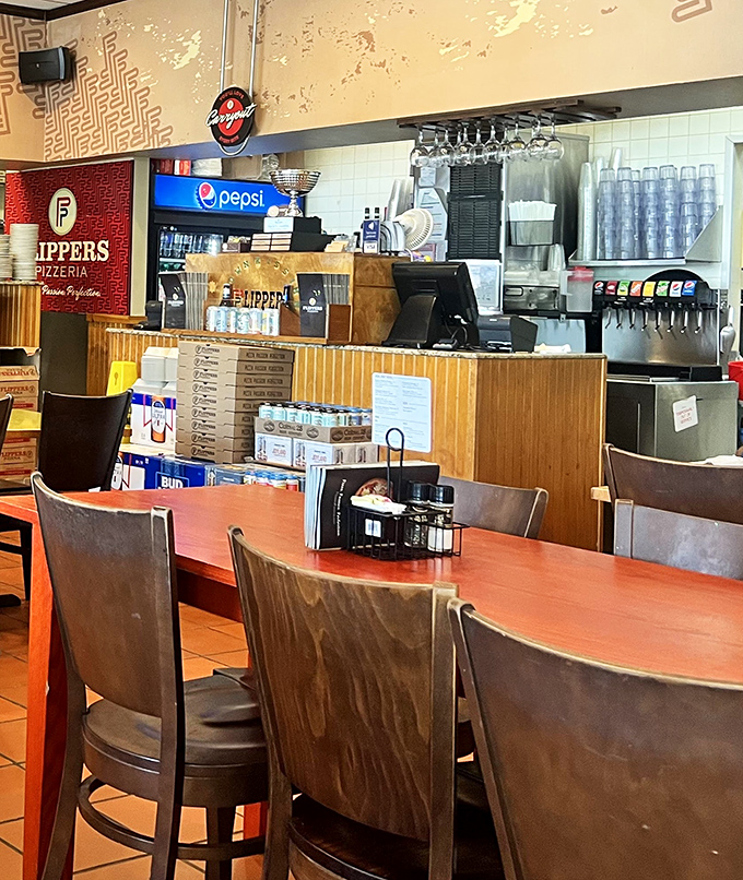 The counter where pizza dreams come true—stacked with boxes ready to transform ordinary evenings into impromptu celebrations.