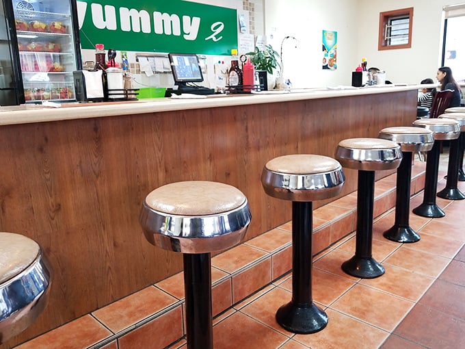Classic diner counter stools—where solo diners become temporary members of the breakfast club and coffee refills appear like magic.