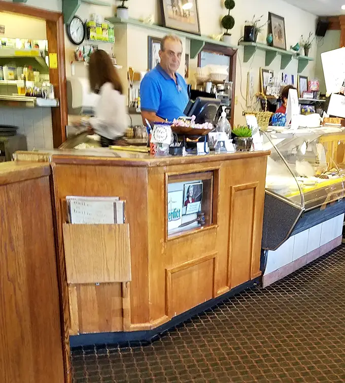 The counter area—where solo diners find community and regulars exchange knowing nods about which specials are worth the caloric investment.
