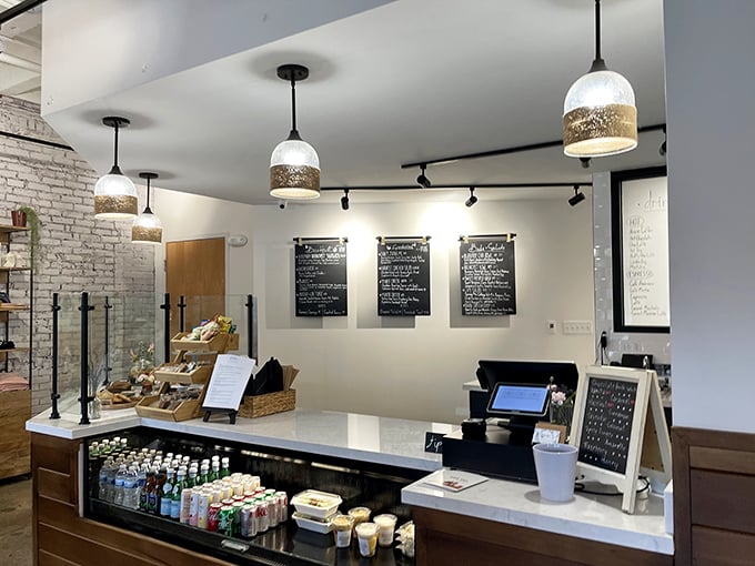 Chalkboard menus and a pristine counter—the stage is set for your daily caffeine performance with optional pastry accompaniment.