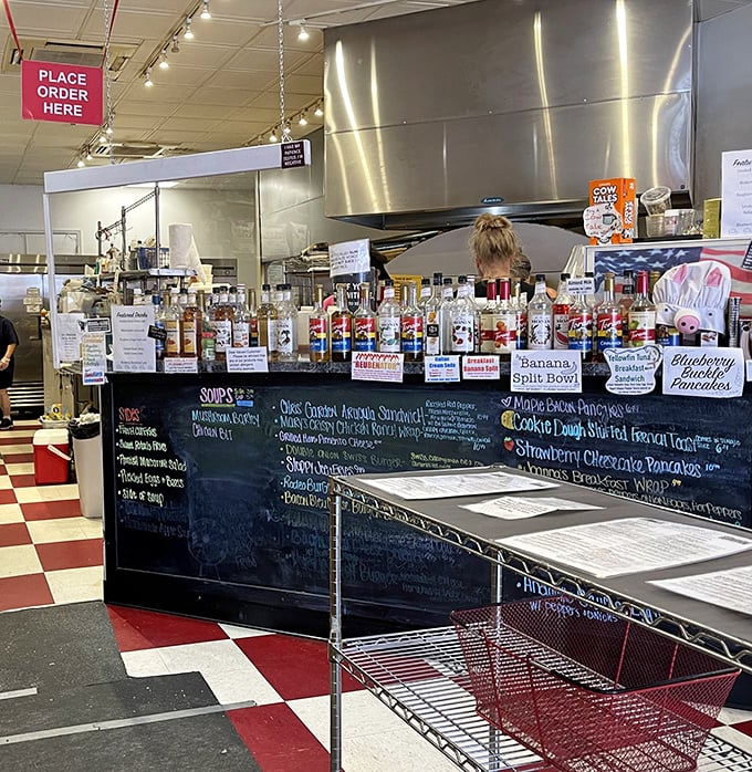 Behind this counter, breakfast magic happens. The chalkboard menu promises everything from banana splits to stuffed French toast—all reasons to extend your visit.