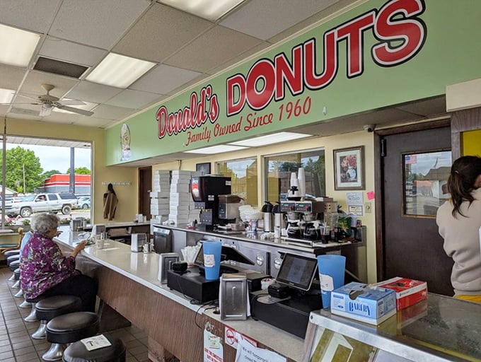 The counter where magic happens daily, complete with the stools that have supported generations of Zanesville's donut enthusiasts.